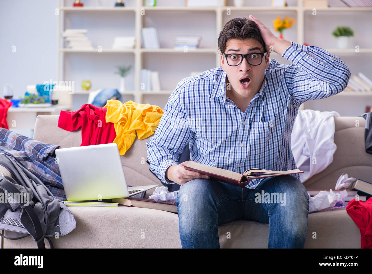 Young man working studying in messy room Stock Photo - Alamy