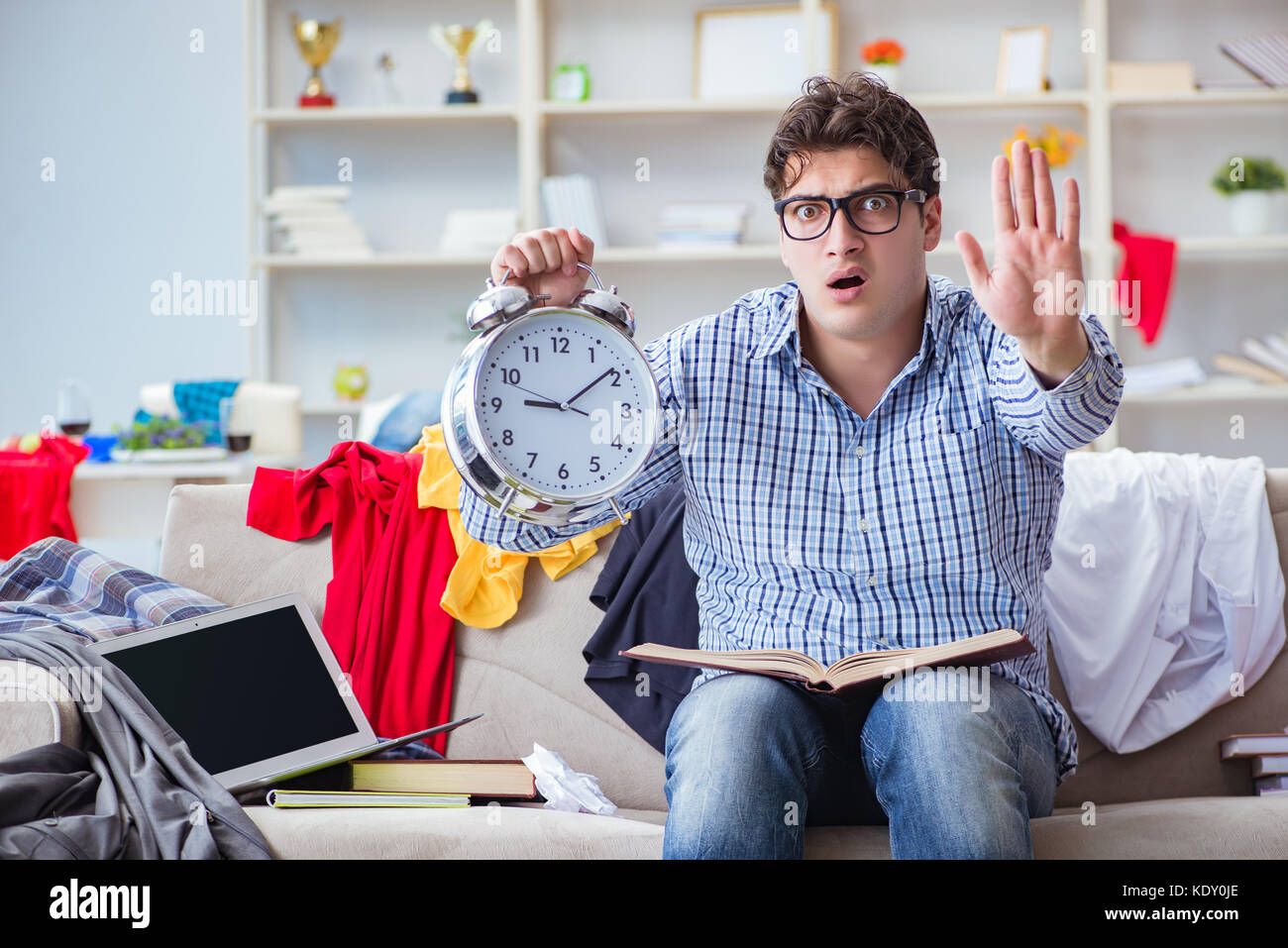 Young man working studying in messy room Stock Photo - Alamy