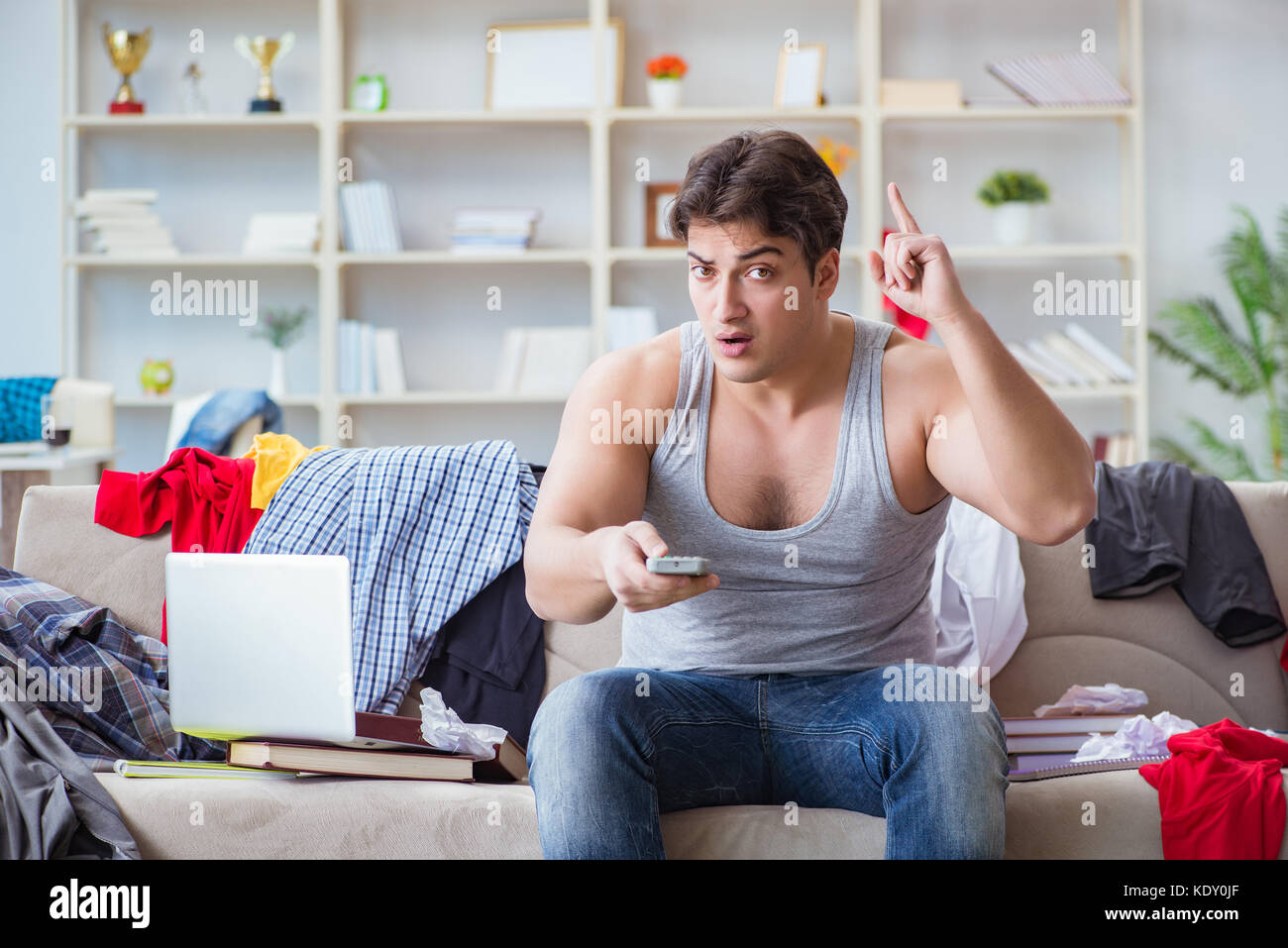 Young man working studying in messy room Stock Photo - Alamy