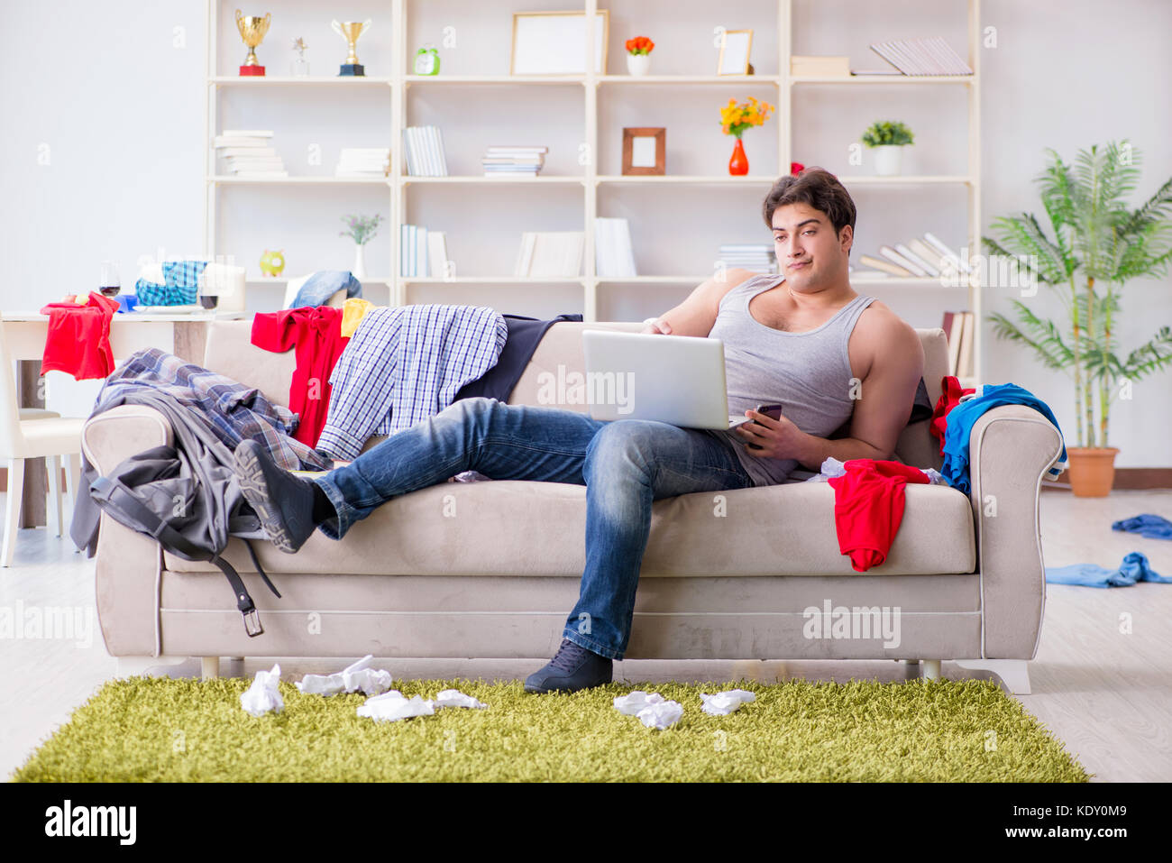 Young man working studying in messy room Stock Photo - Alamy