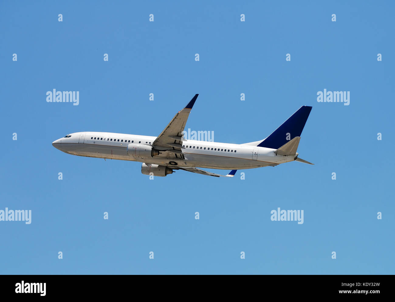 Modern passenger jet taking off with gear up Stock Photo - Alamy