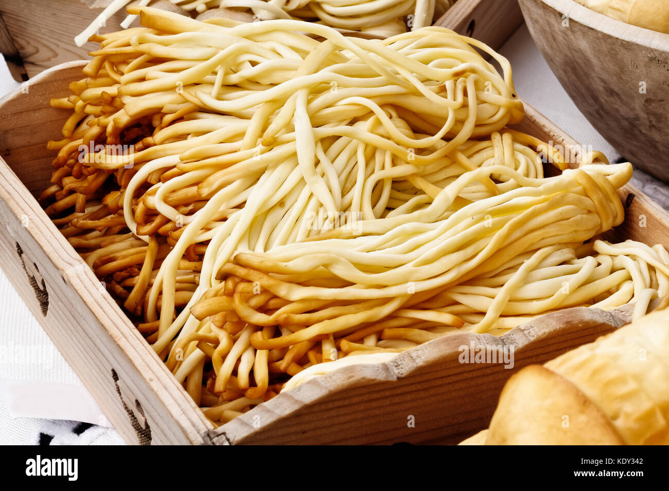 Kobarcik smoked string cheese on a wooden tray Stock Photo - Alamy