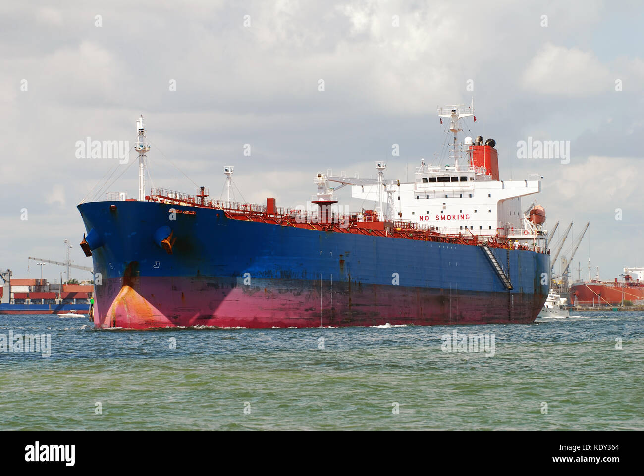 Cargo ship leaving port Stock Photo - Alamy
