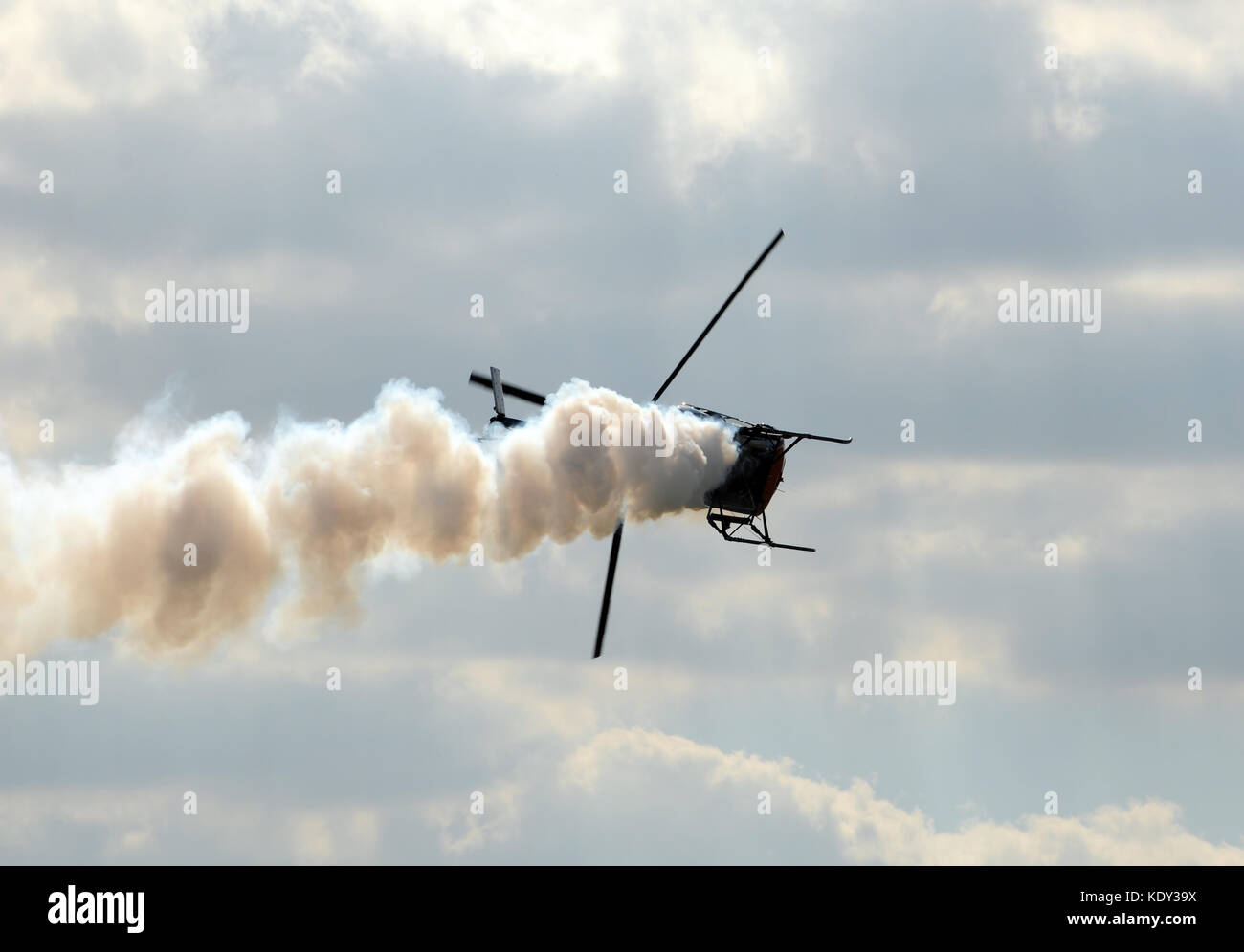 Light helicopter with smoke making emergency landing Stock Photo - Alamy