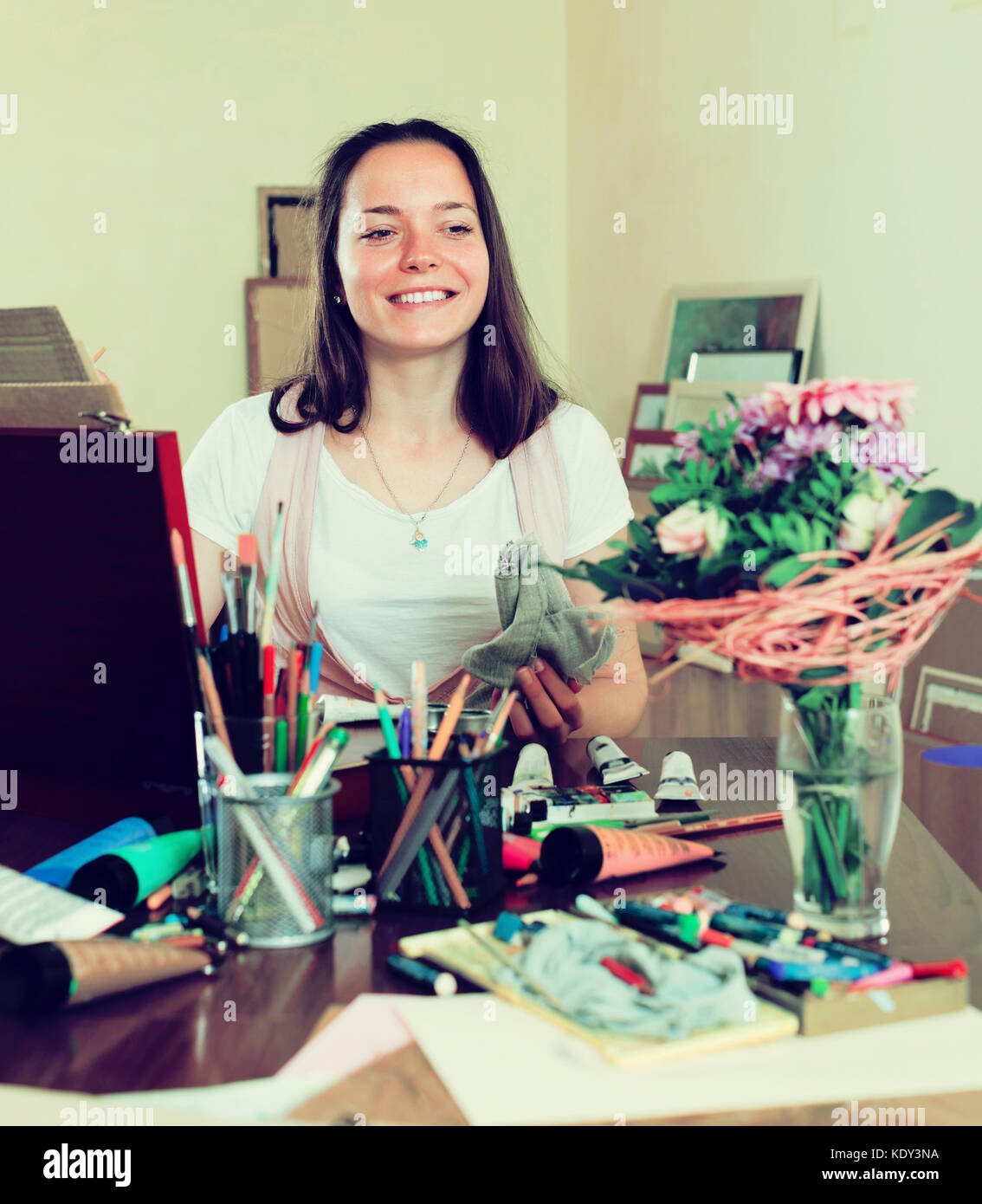 Smiling artist in the process of creating a new picture Stock Photo - Alamy