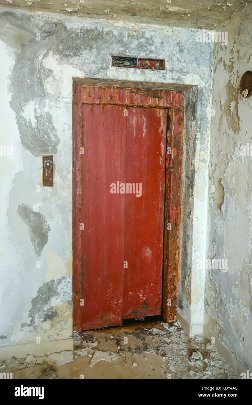 The red doors of an old ruined hotel Stock Photo - Alamy