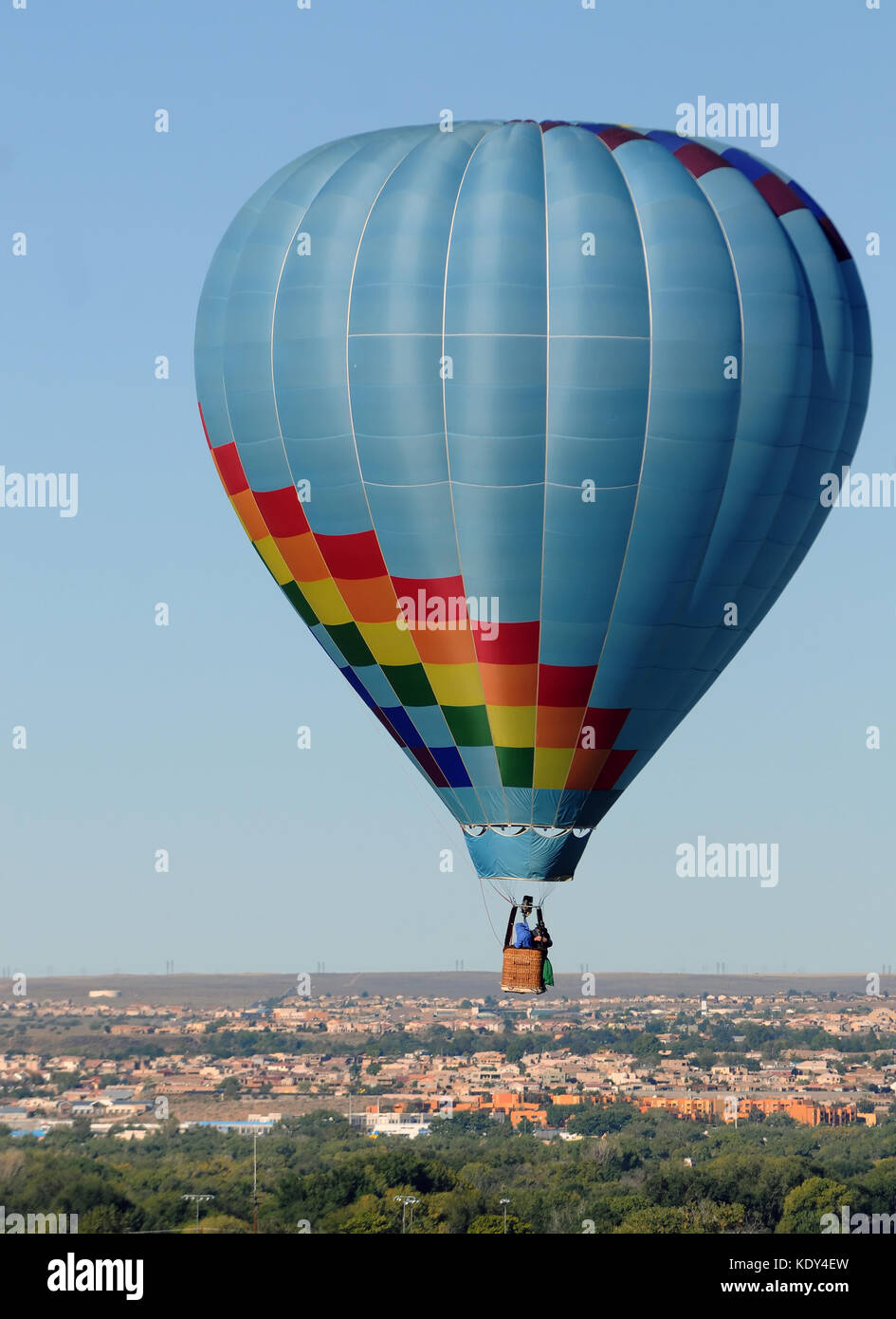 Colorful hot air balloon floating over countryside Stock Photo - Alamy