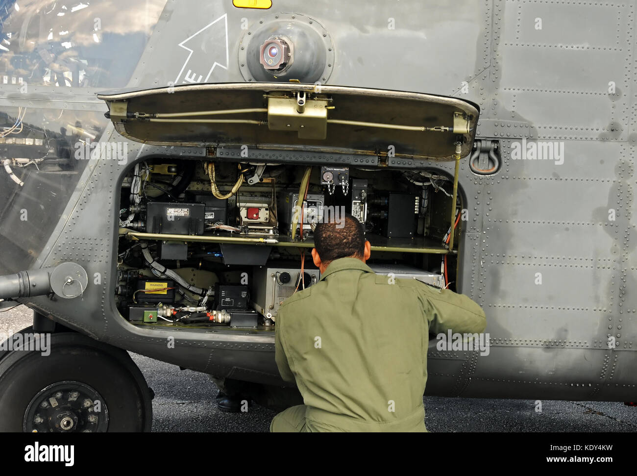 Engineer maintaining a heavy marine helicopter Stock Photo - Alamy