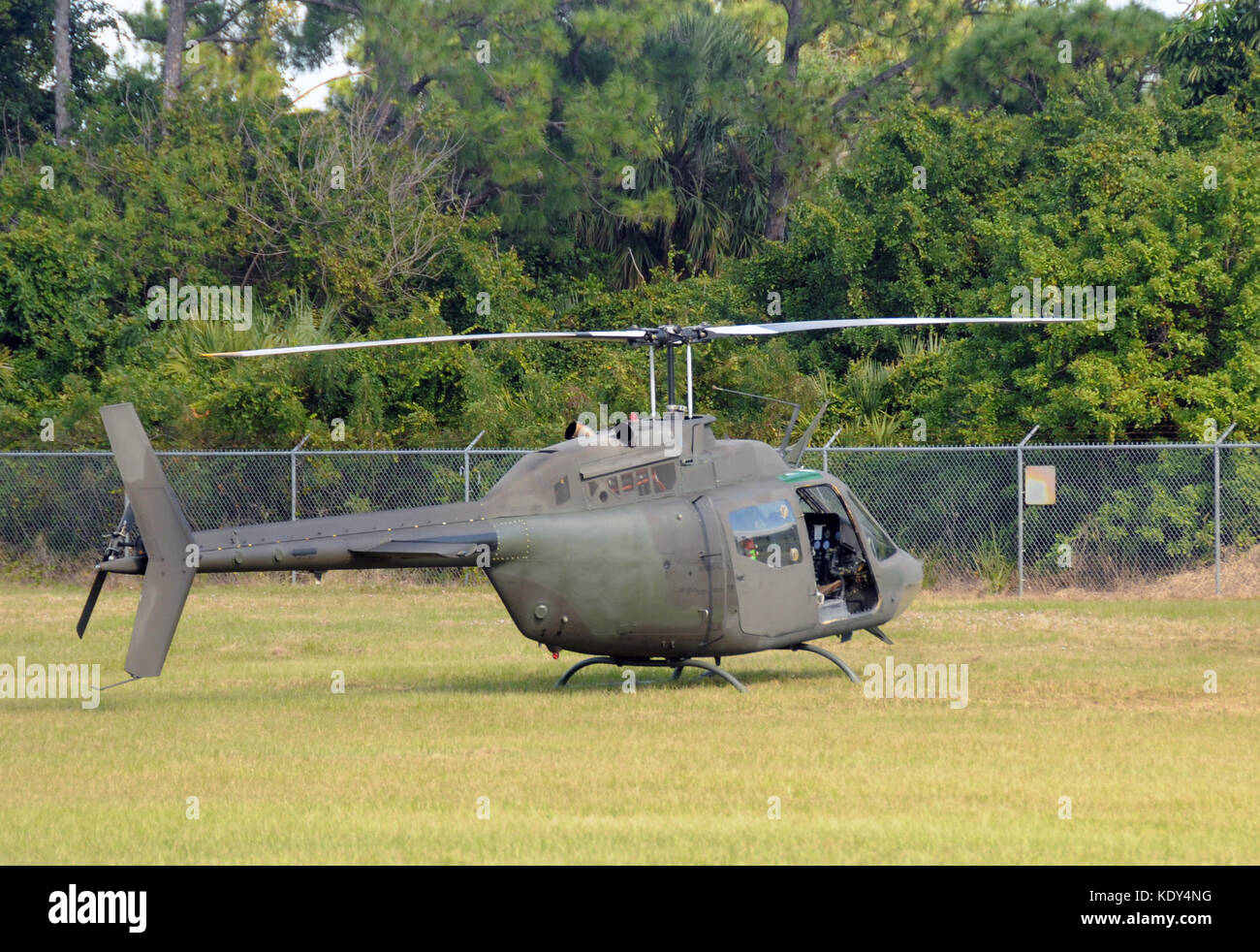 Military helicopter parked on a green field Stock Photo - Alamy