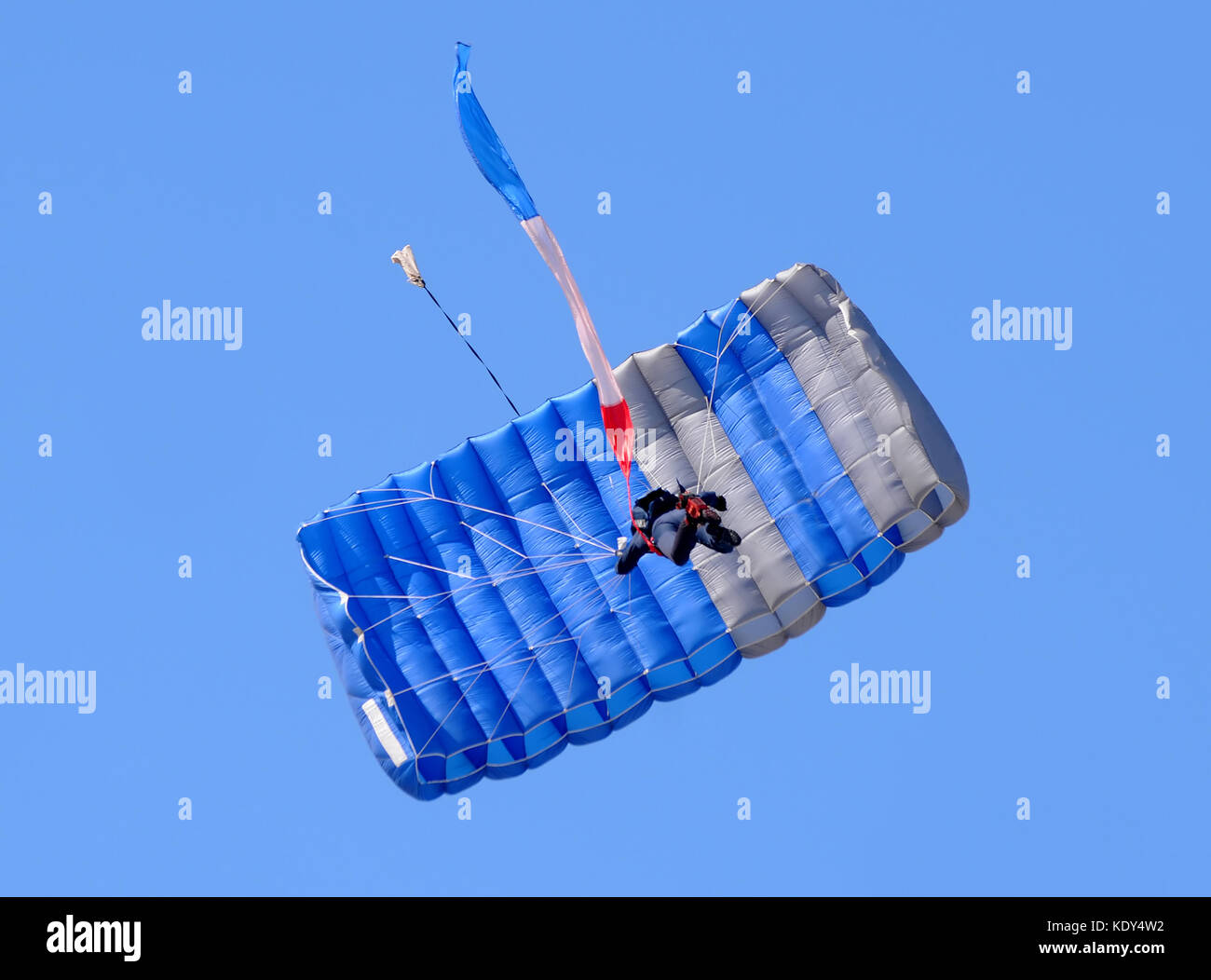 Skydiver with blue parachute seen from below Stock Photo - Alamy