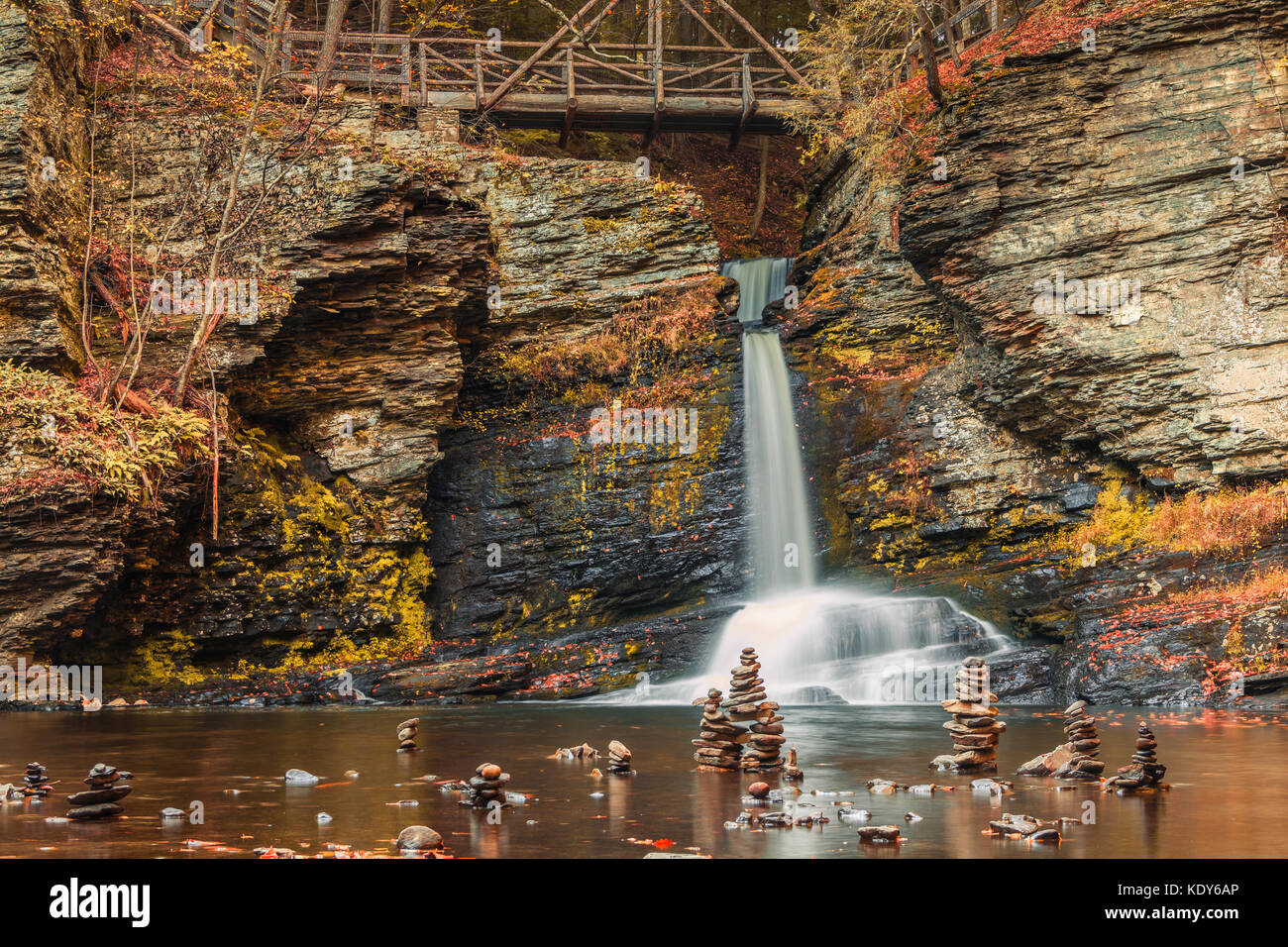 Dear Leap Waterfalls flow smoothly over rocks surrounded by peak fall ...