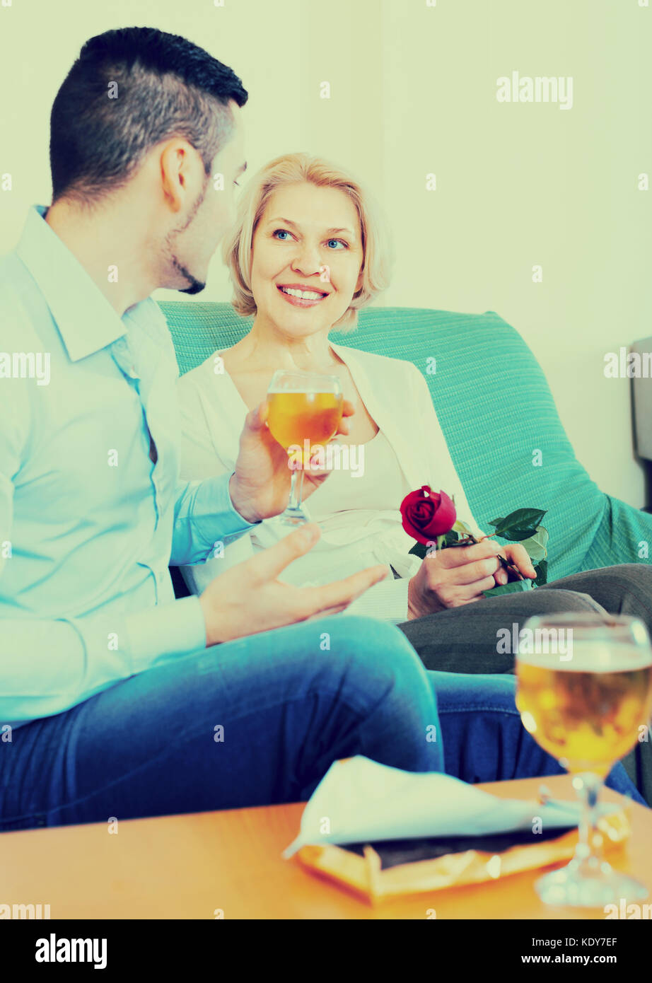 Adult son congratulating happy smiling mother and proposing a toast ...