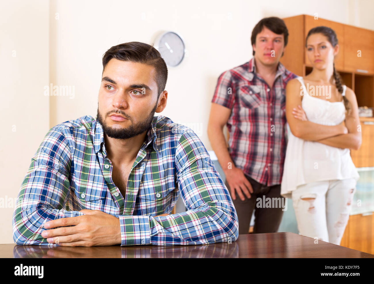 Two man quarreling over a girl at home Stock Photo - Alamy