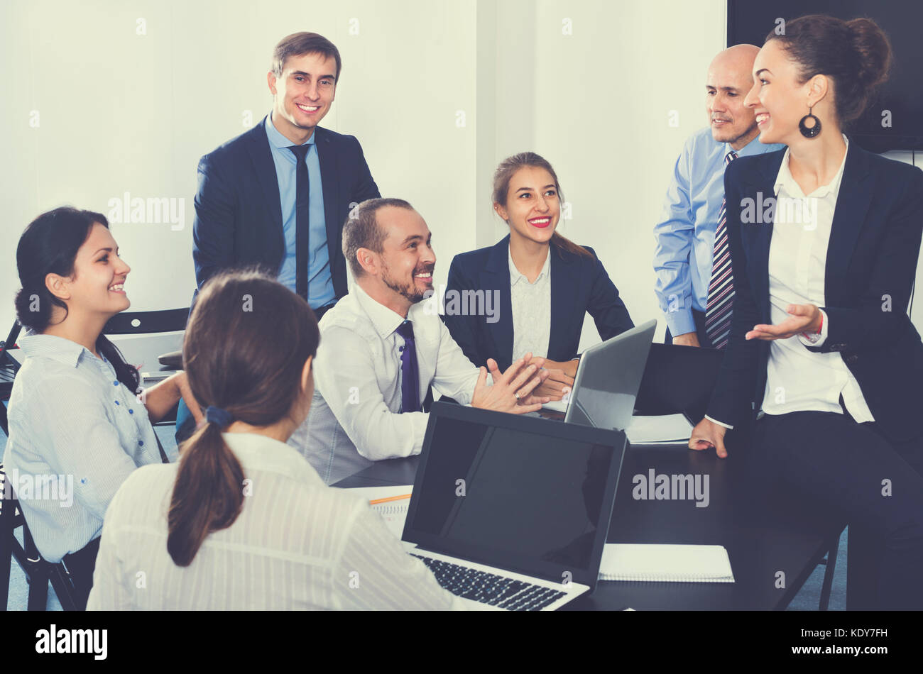 Positive working team sharing ideas on project during coffee break in ...