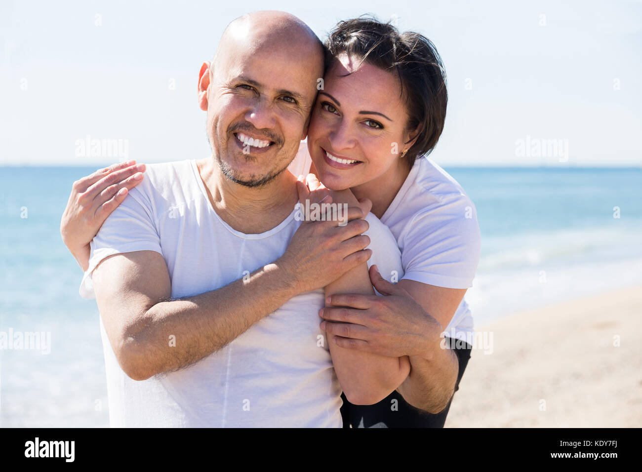 mature spanish couple smiling holding each other on the beach Stock ...