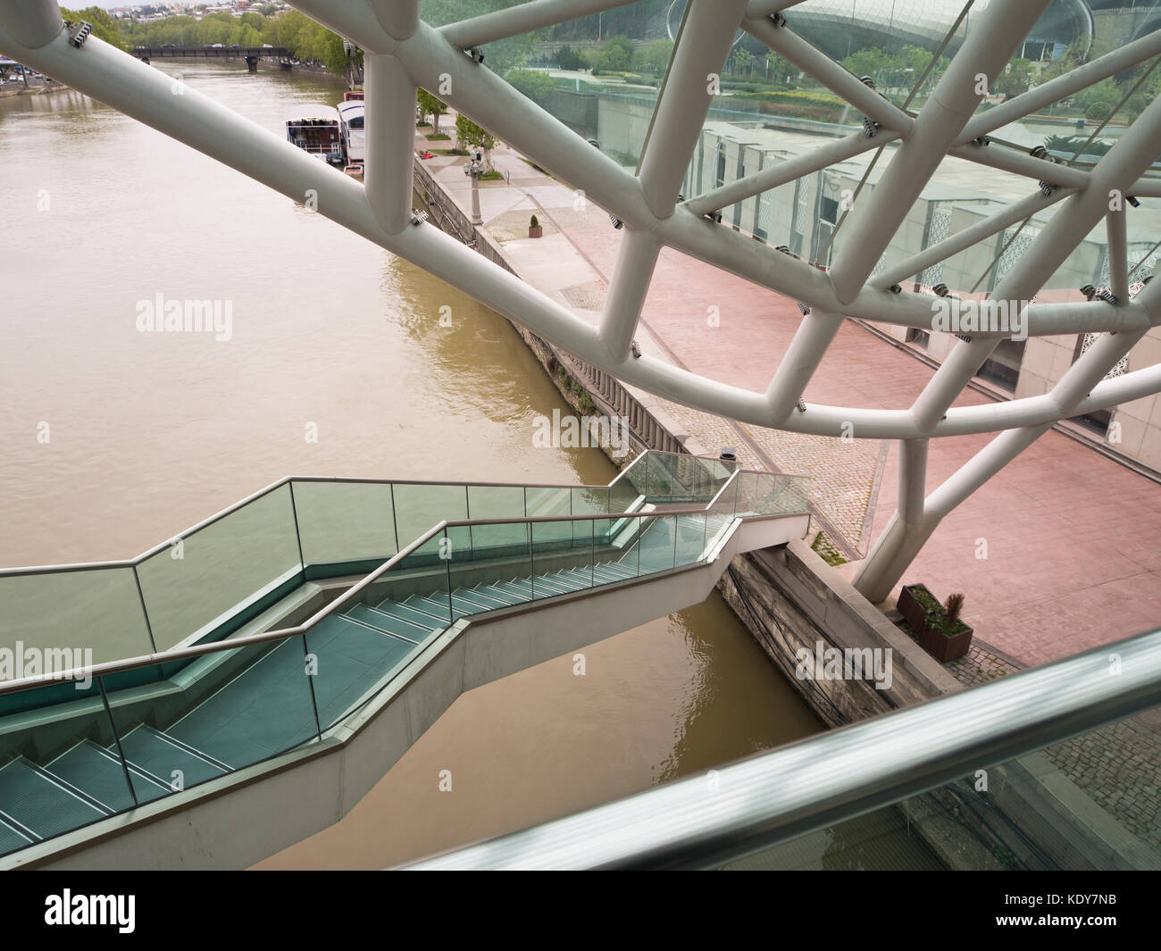 Modern architectural design in a footbridge crossing the river Kura in ...
