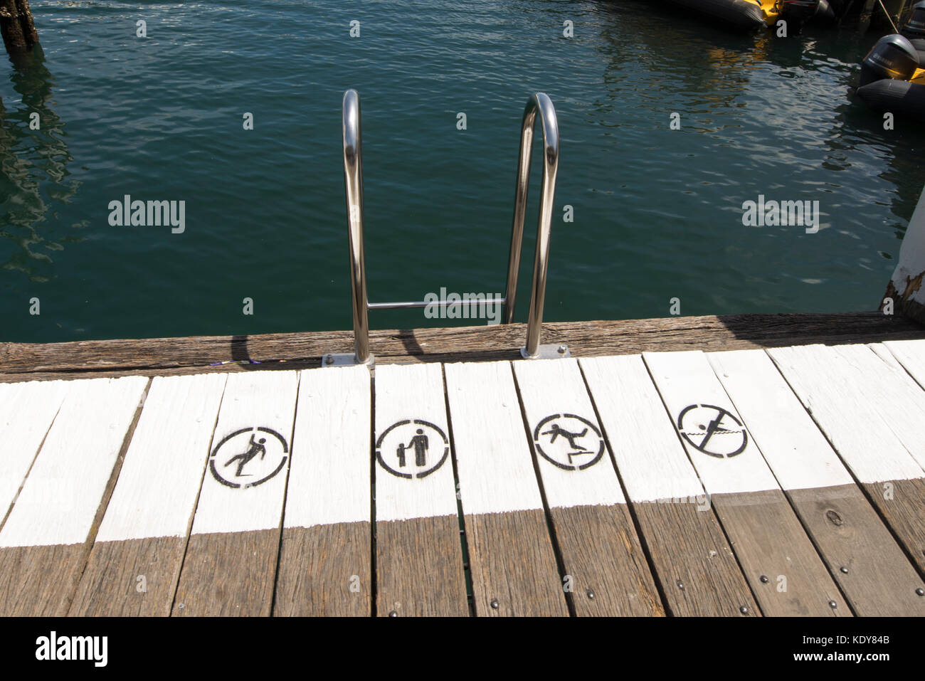 Warning signs next to steps at Darling harbour Stock Photo - Alamy