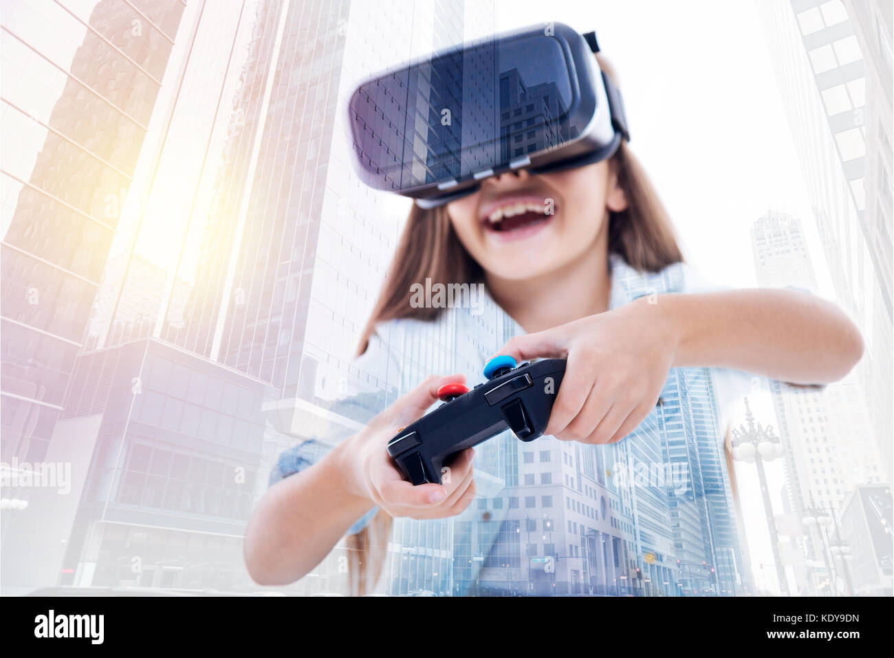 Happy girl in VR headset using video game controller Stock Photo - Alamy