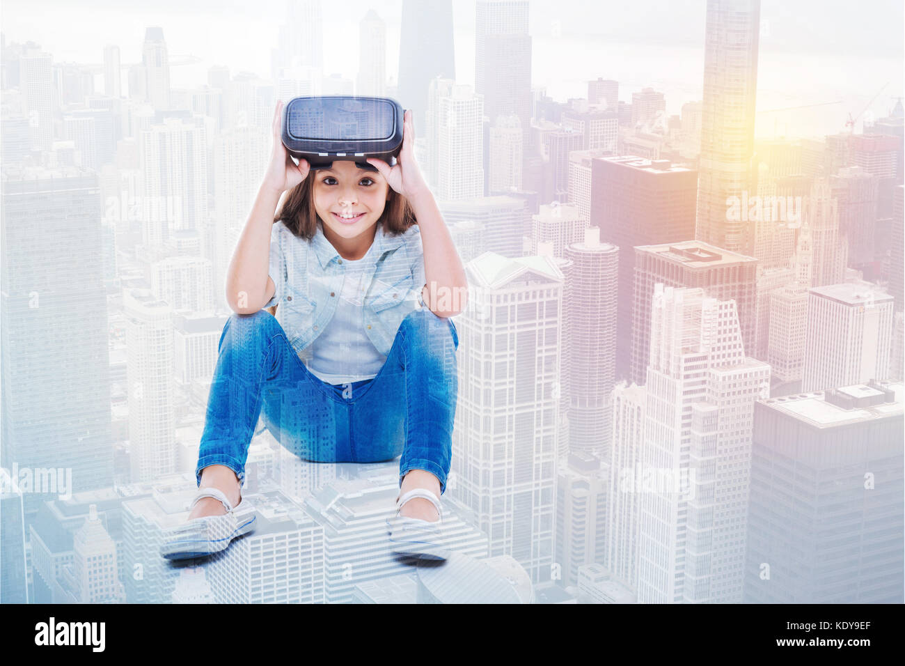 Smiling girl posing while removing VR headset Stock Photo - Alamy