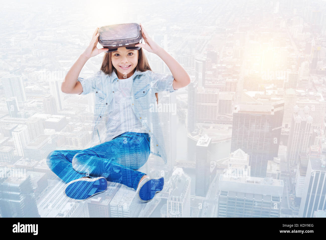 Little girl removing VR headset and smiling Stock Photo - Alamy