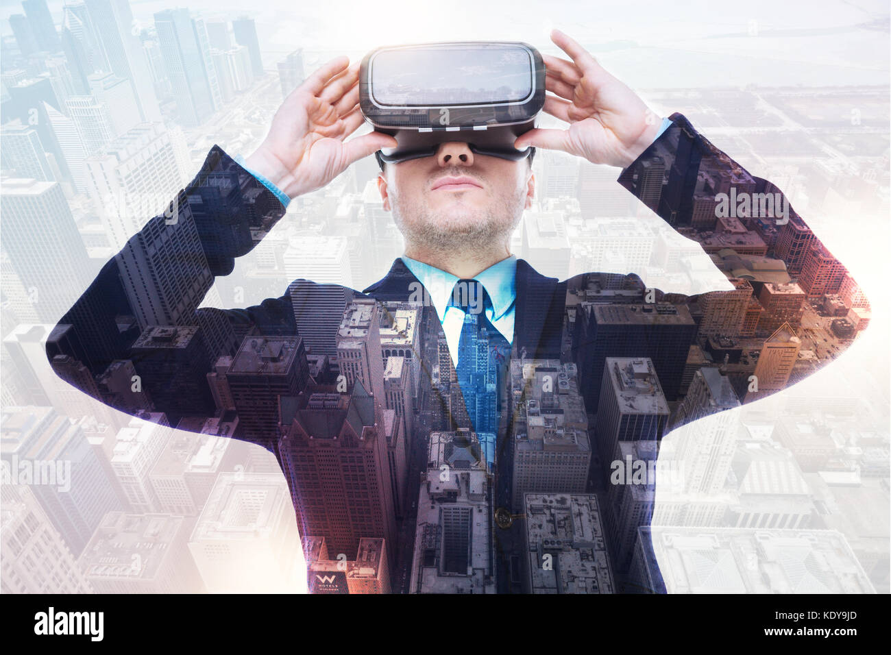 Pleasant businessman looking up while wearing VR headset Stock Photo ...