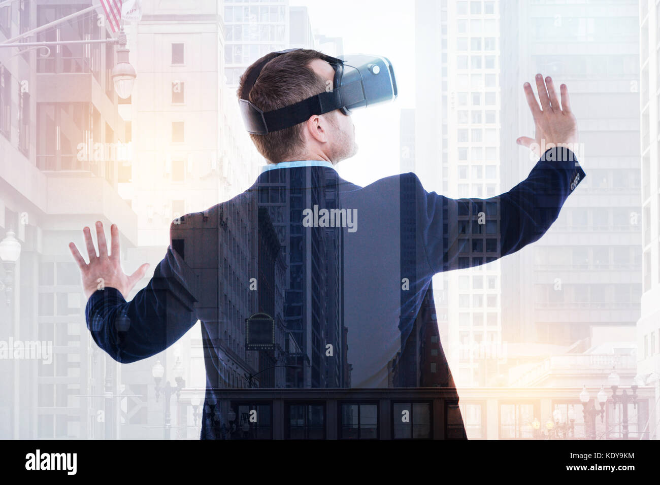 Back view of businessman wearing VR headset and spreading hands Stock ...