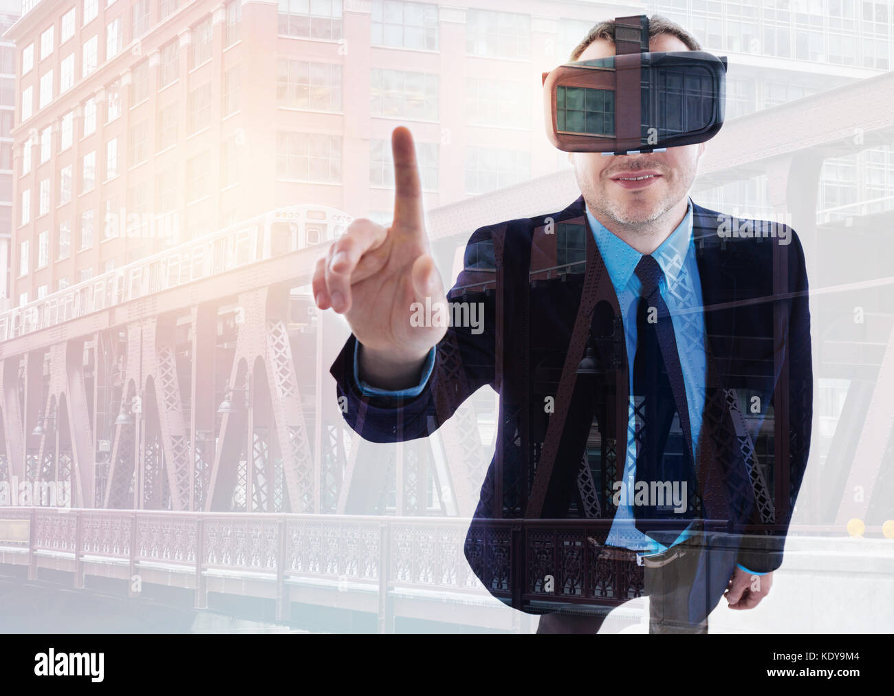 Pleasant businessman in VR headset showing index finger Stock Photo - Alamy