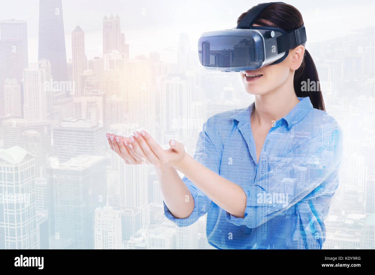 Charming woman cupping her hands while wearing VR headset Stock Photo ...