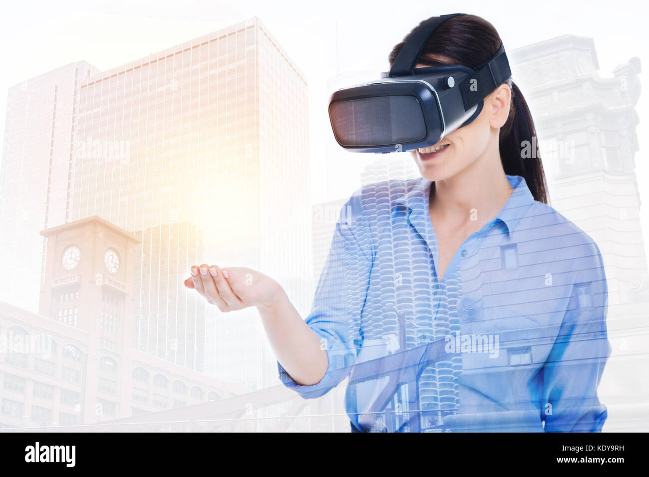 Beautiful woman in VR headset holding virtual object in hand Stock ...