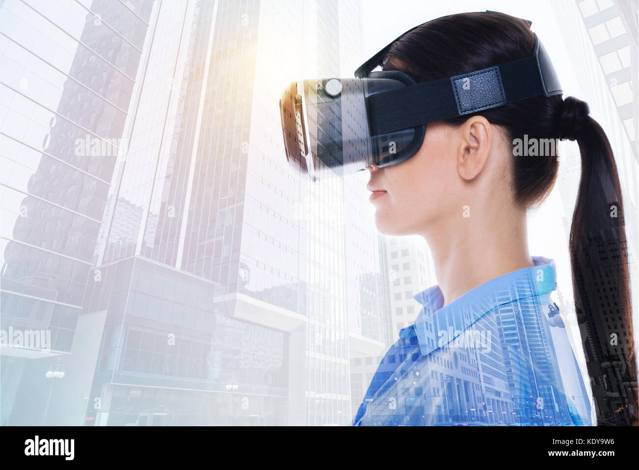 Side view of pretty woman wearing VR headset Stock Photo - Alamy