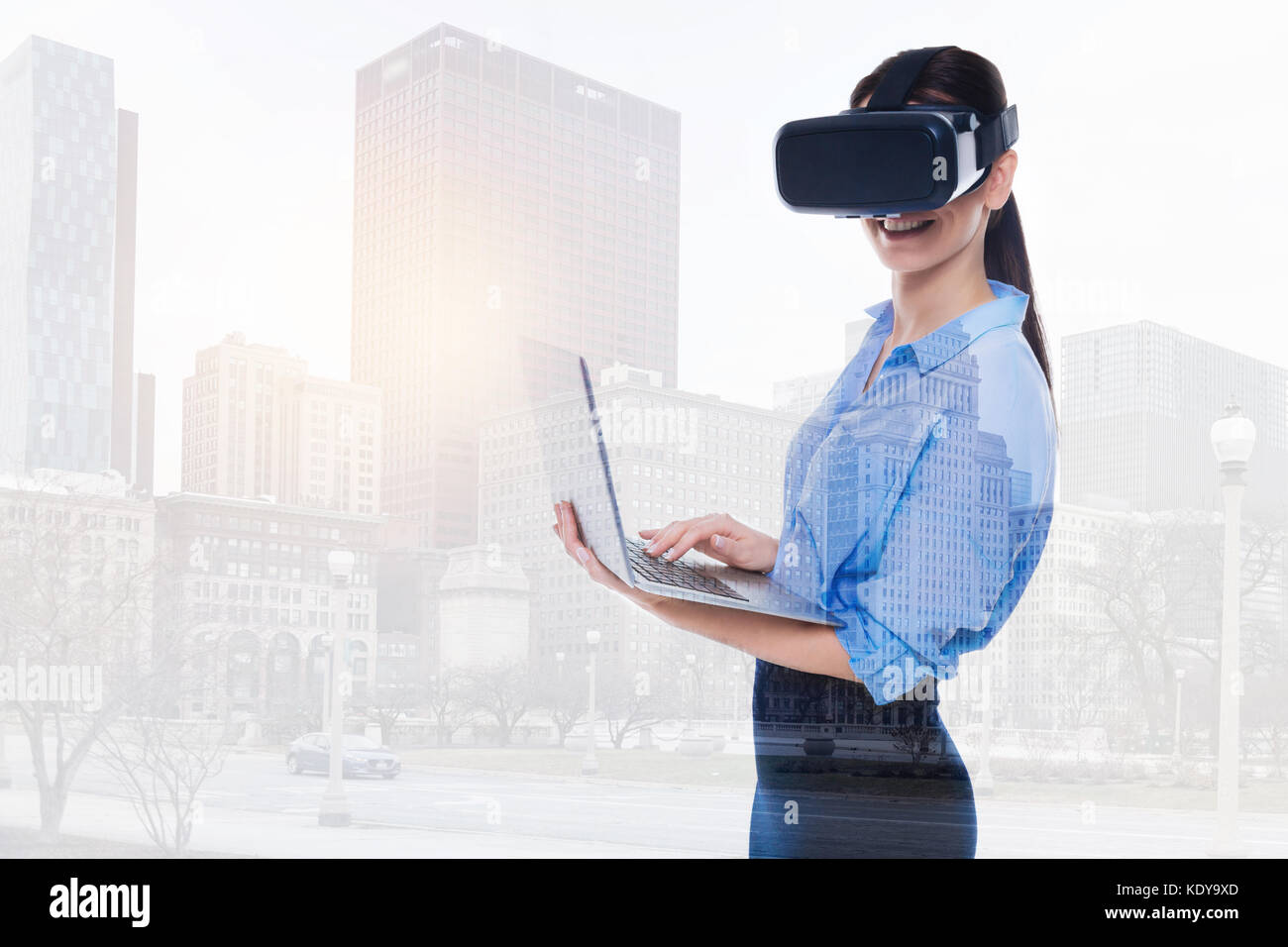 Beautiful woman in VR headset posing with laptop Stock Photo - Alamy