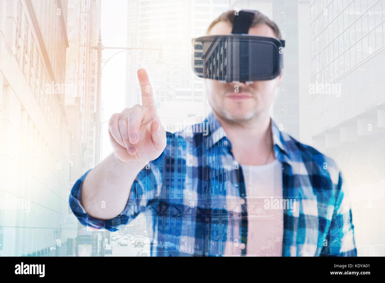Smiling man raising index finger while wearing VR goggles Stock Photo ...