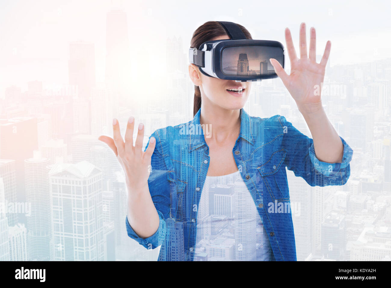 Smiling woman experiencing virtual reality game Stock Photo - Alamy