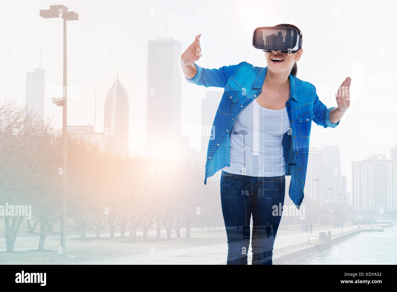 Pretty woman in VR headset pushing virtual borders Stock Photo - Alamy