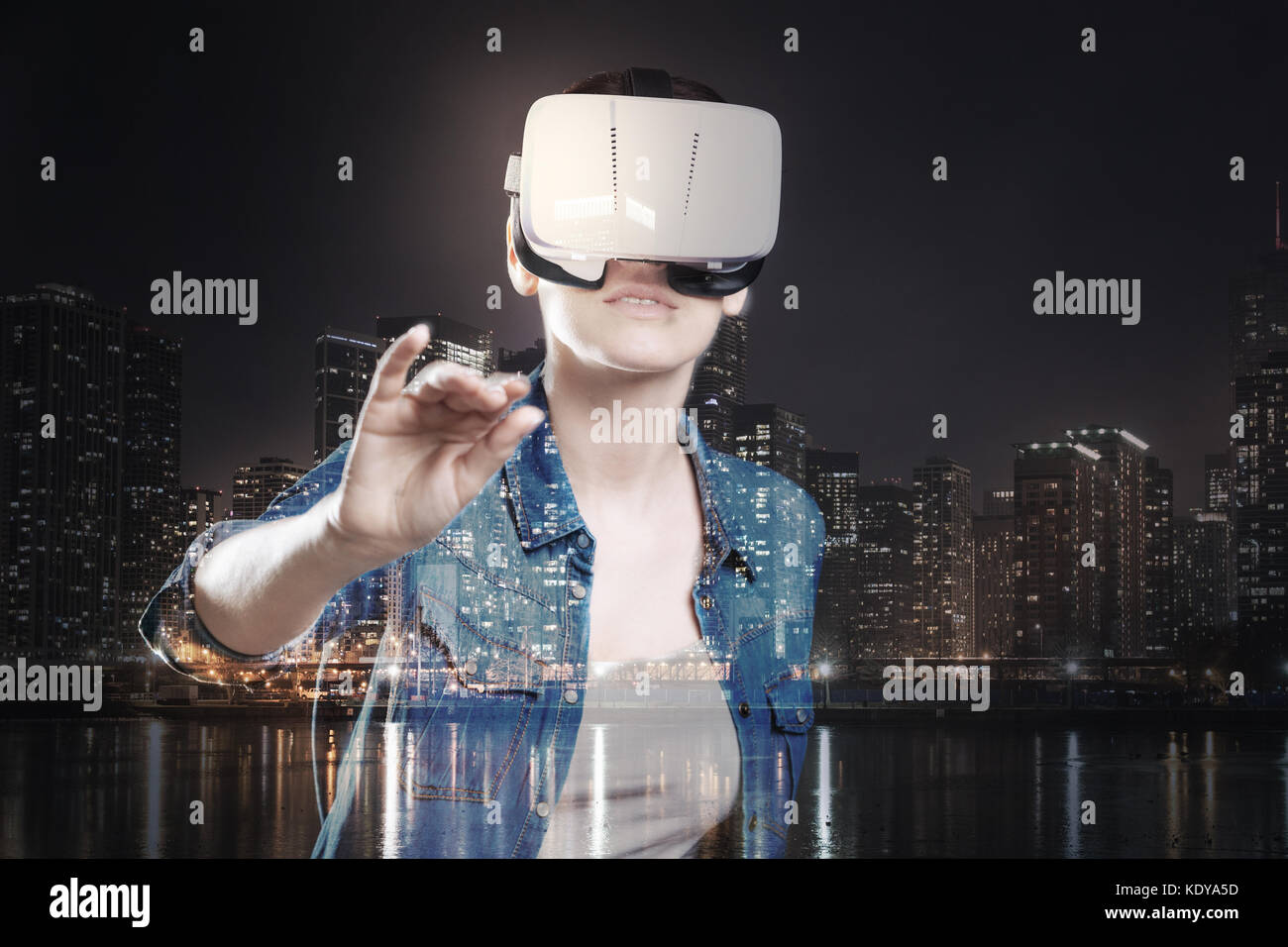 Pretty woman in VR headset putting her hand forward Stock Photo - Alamy