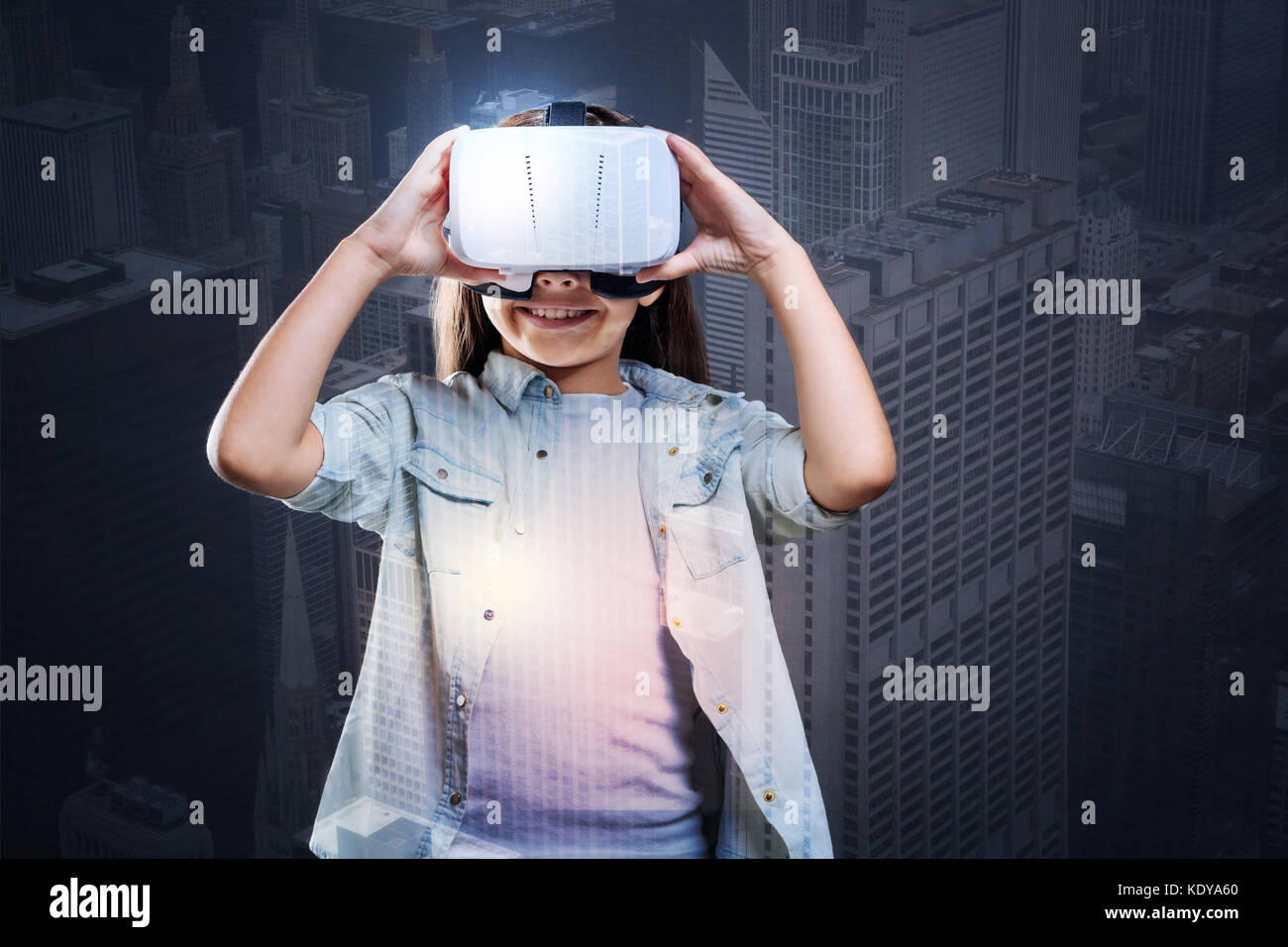 Little girl putting on a VR headset Stock Photo - Alamy