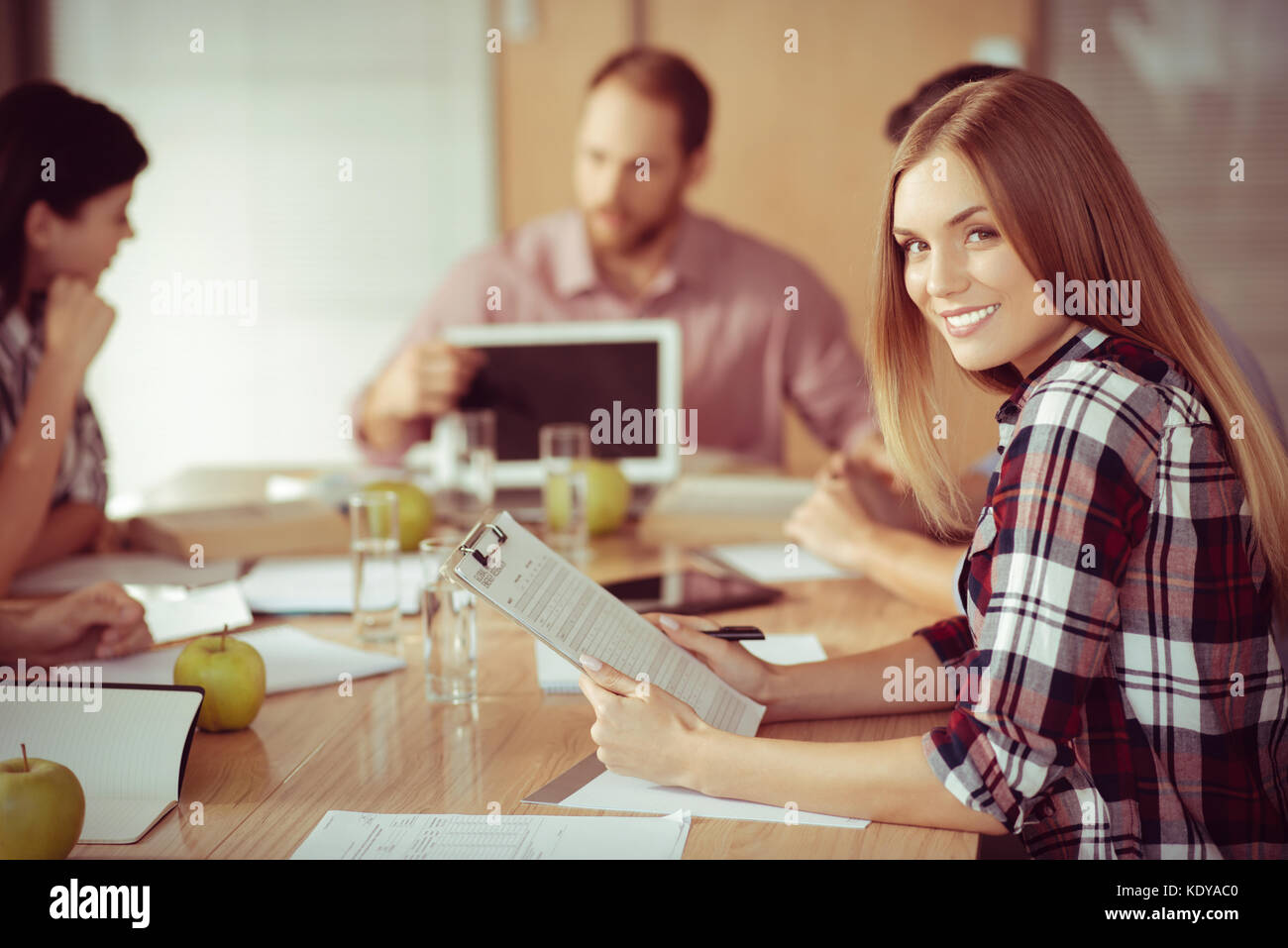 Cheerful beautiful woman holding her notes Stock Photo - Alamy