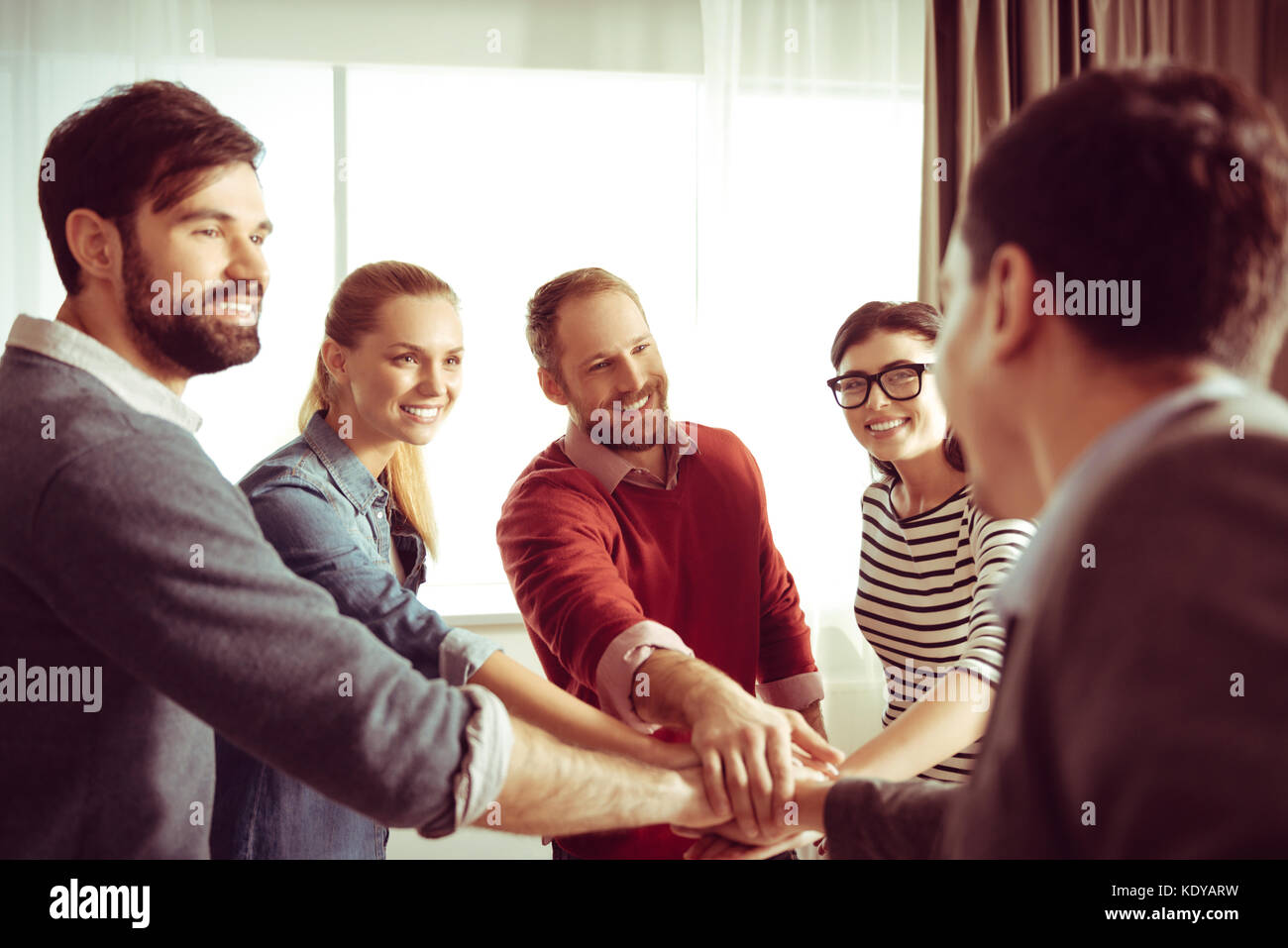 Positive cheerful team standing in the circle Stock Photo - Alamy