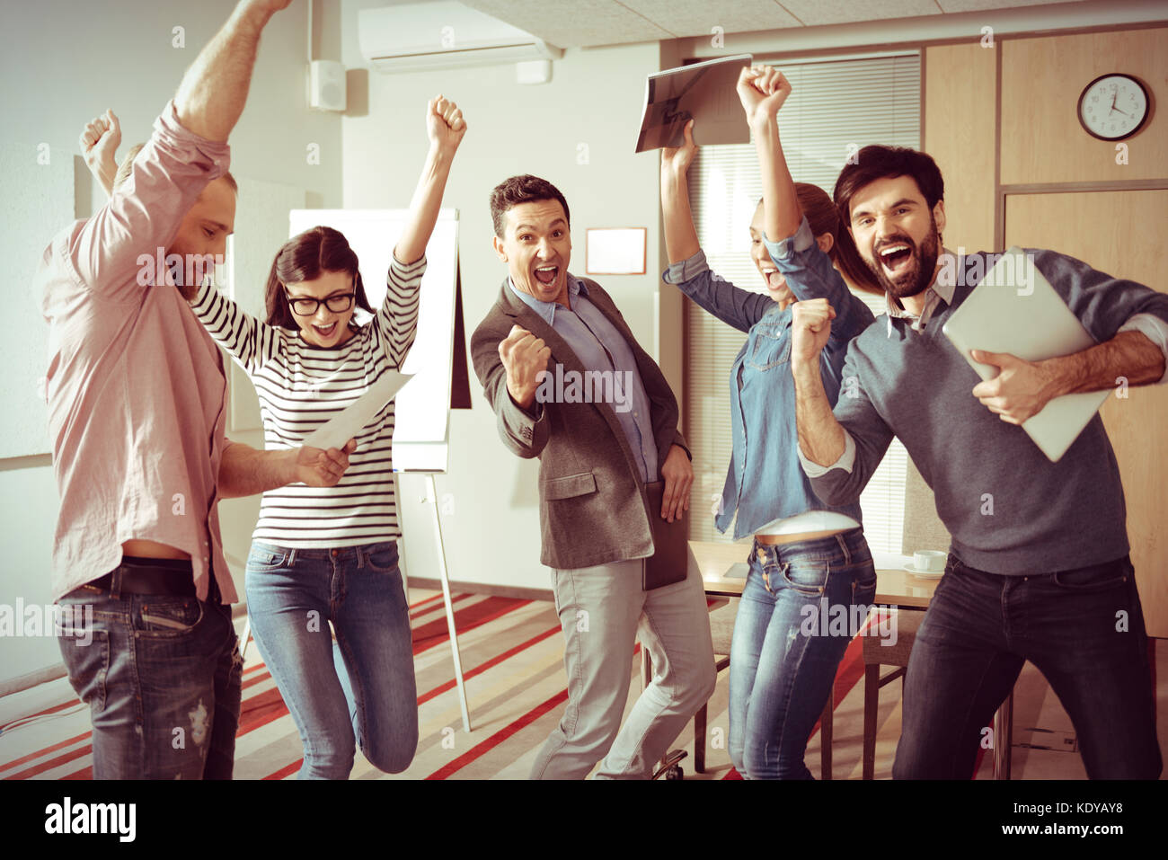 Happy delighted team showing their emotions Stock Photo - Alamy