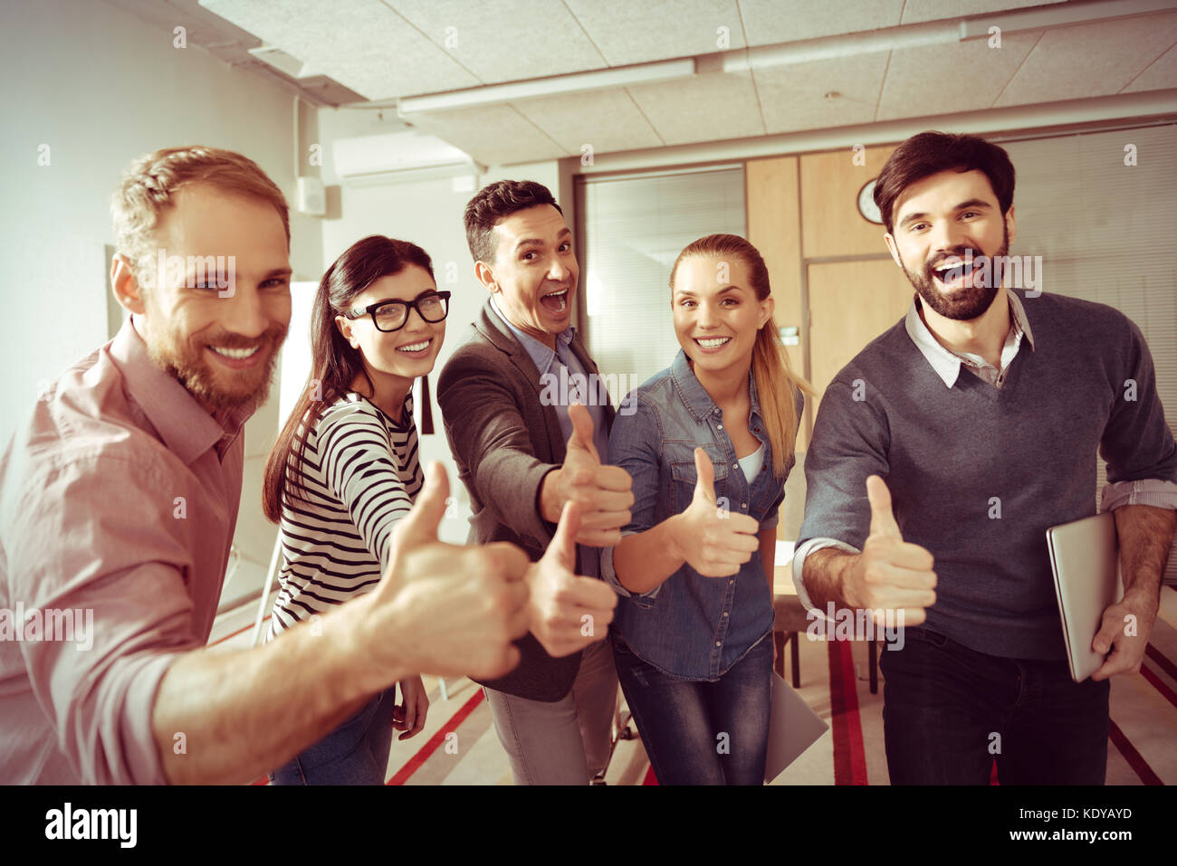 Positive young team showing OK gestures Stock Photo - Alamy