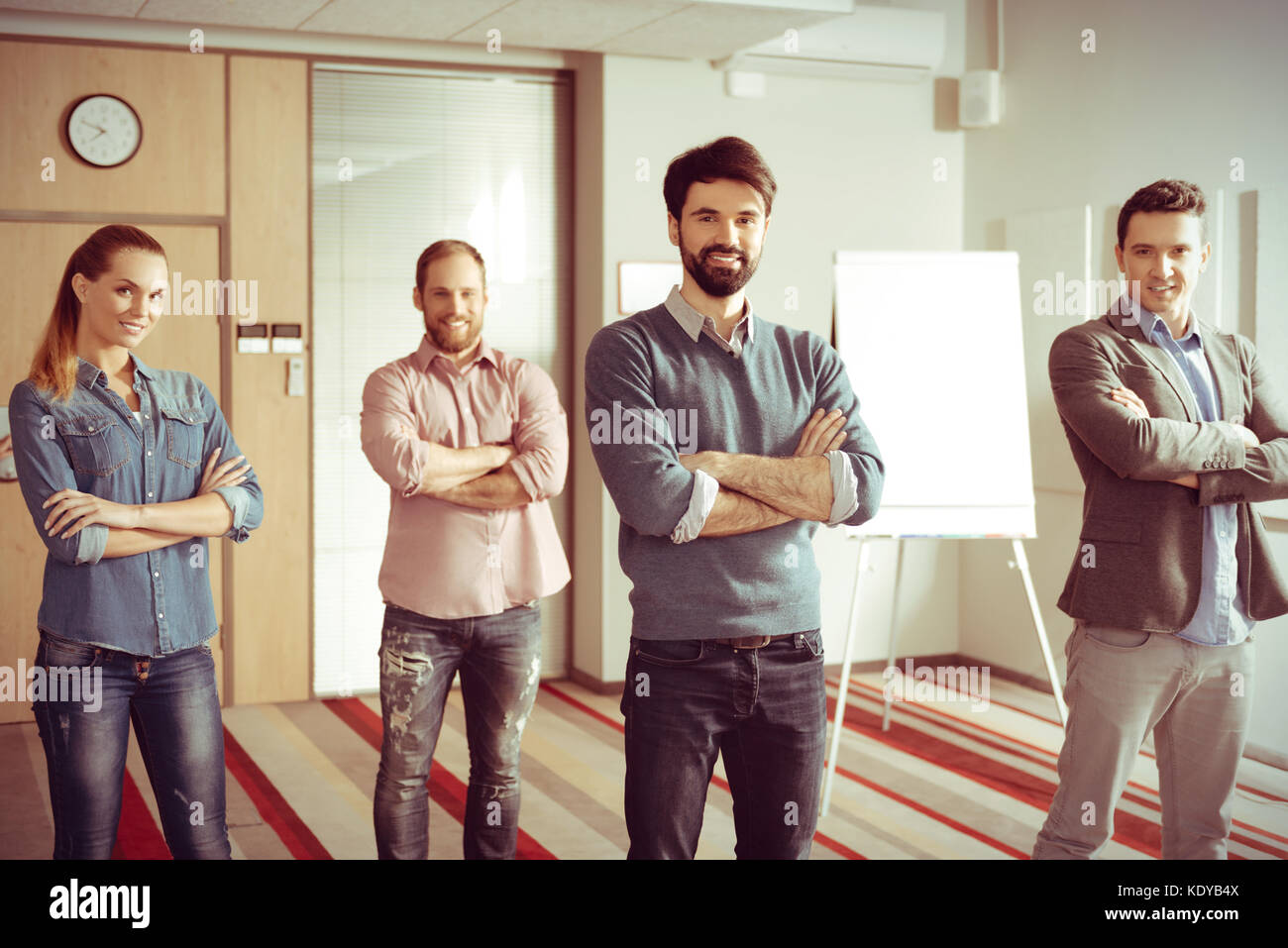 Smart confident people standing cross handed Stock Photo - Alamy