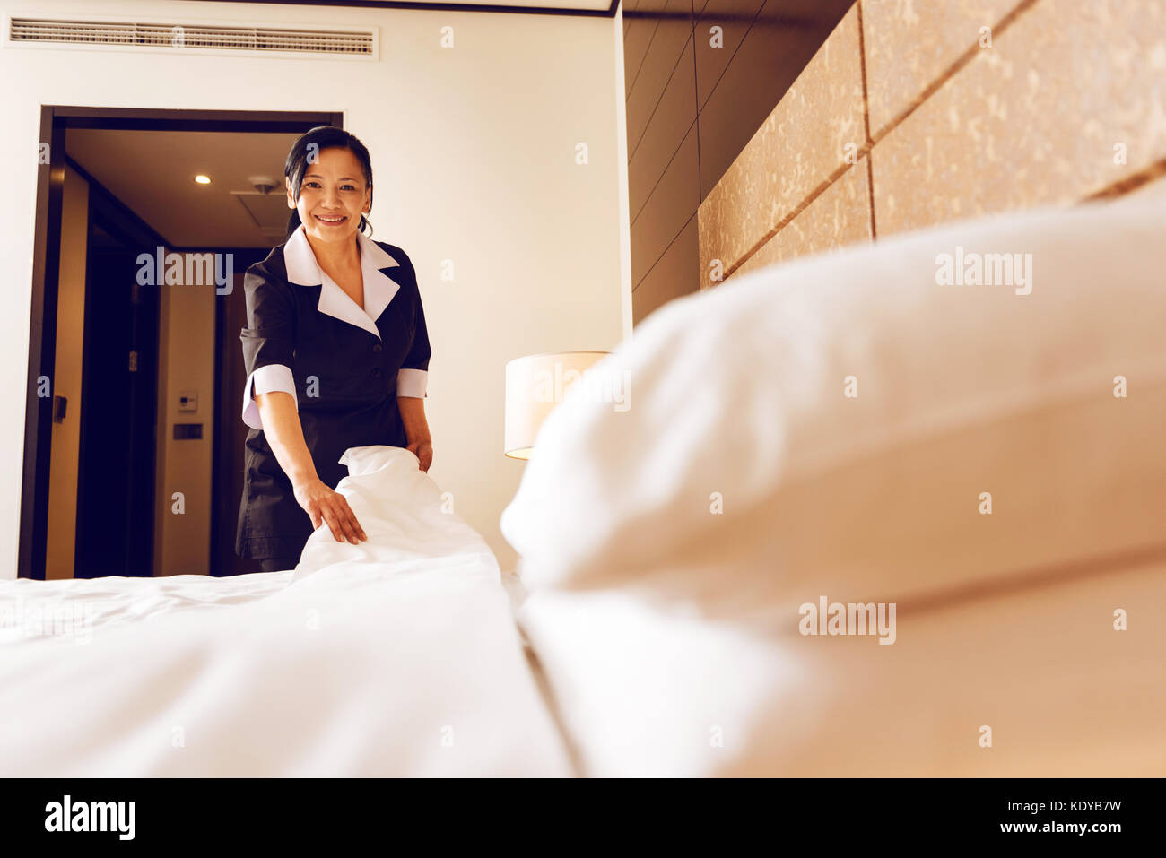 Smiling woman working as hotel maid Stock Photo - Alamy
