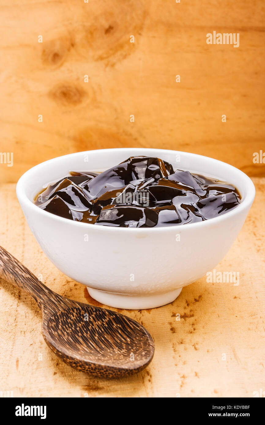 grass jelly or vegetable jelly on wood background Stock Photo - Alamy