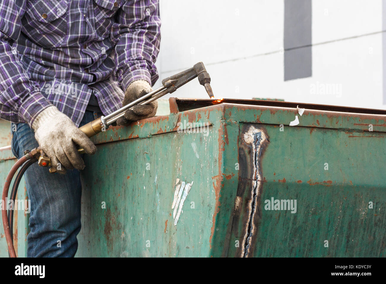 welder worker with cutting torch cutting a steel oxygen propane cutting ...