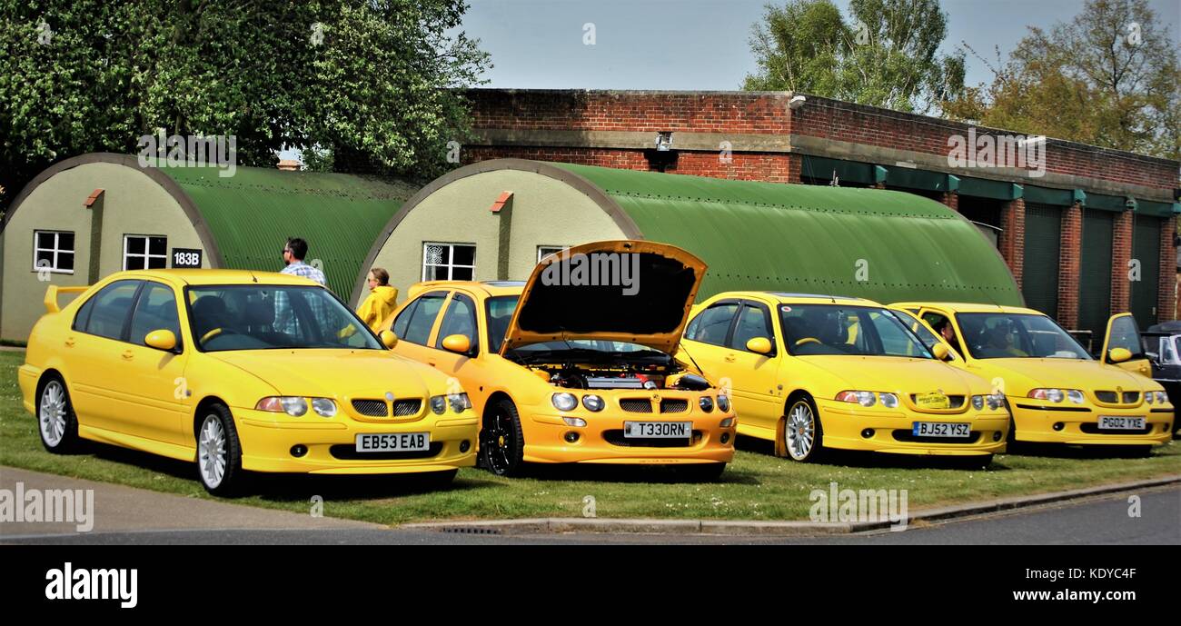 row of yellow MG cars in front of the Nissan huts at the classic sport ...