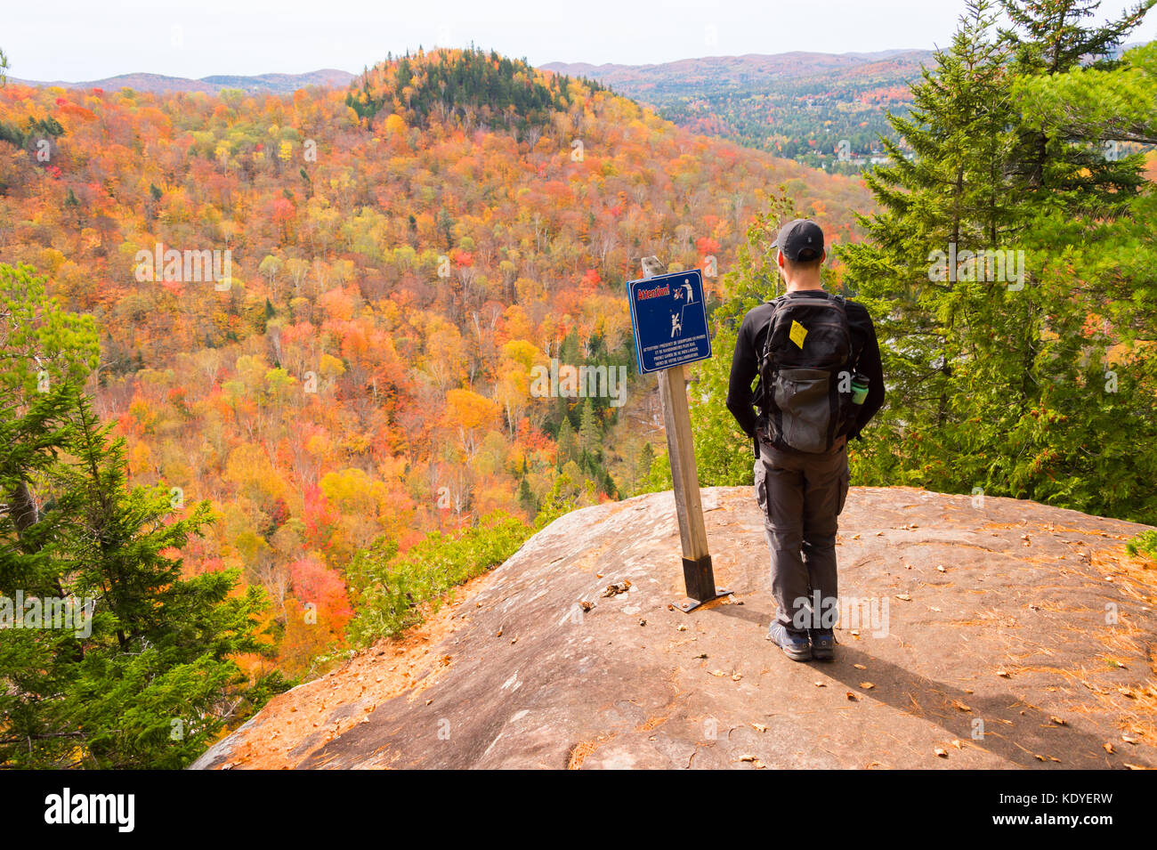 Young man standing at panoramic lookout in Val David Regional Park ...