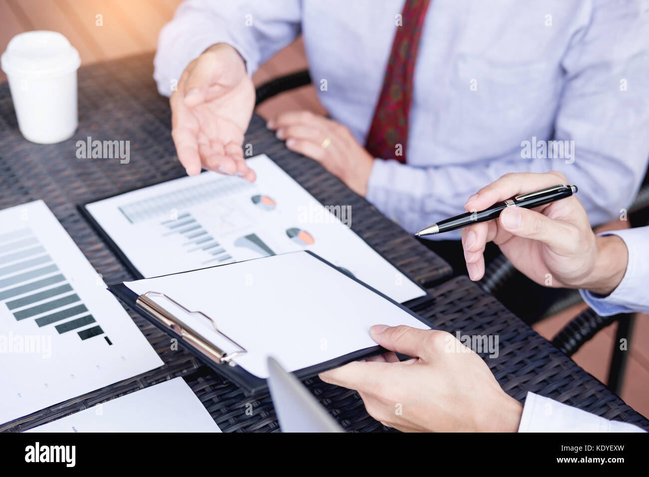 Business people discuss together about there work by graph document and ...