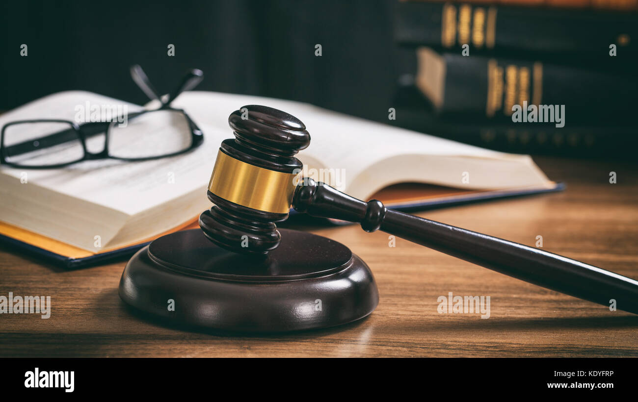 Law gavel on a wooden desk, law books background Stock Photo - Alamy