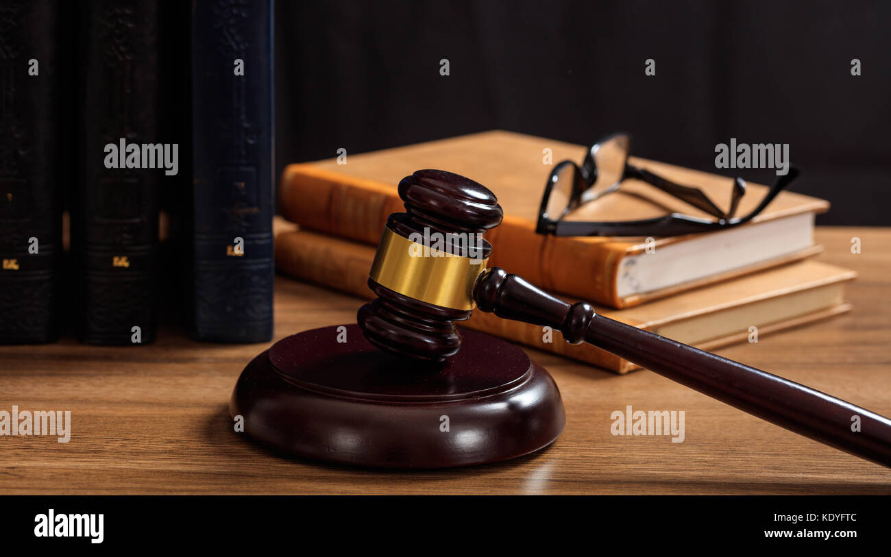 Law gavel on a wooden desk, law books background Stock Photo - Alamy