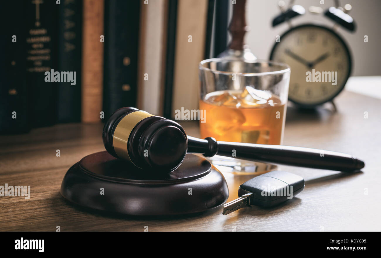 DUI concept. Law gavel, alcohol and car keys on a wooden desk, dark ...